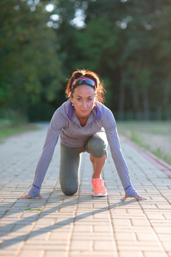 Female Runner Ready for Running Sprint. Woman at Starting Line I Stock ...