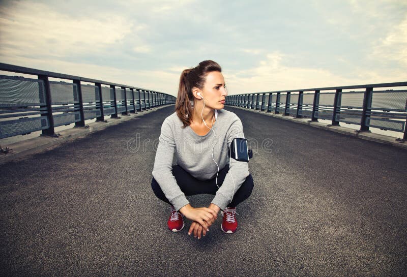 Female Runner Sitting stock photo. Image of girl, listening - 32903512