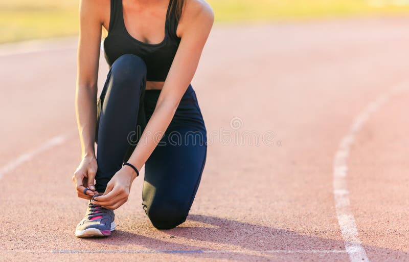 Female Runner Tying Lace on Stadium. Stock Photo - Image of exercise ...