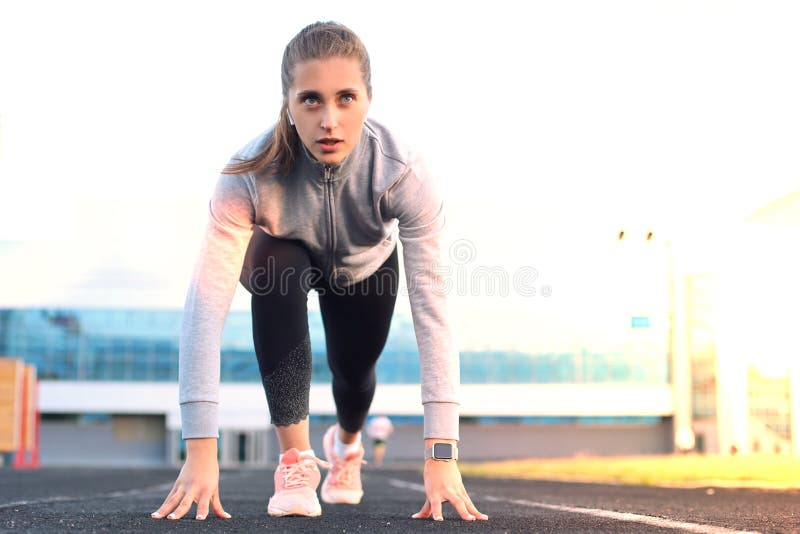 Female Runner Waiting for the Start on the Start Line in Stadium Stock ...