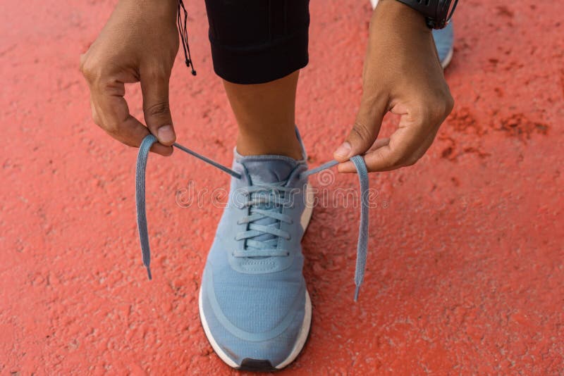 Female Runner Who Ties Her Sneaker Laces before Running Stock Photo ...