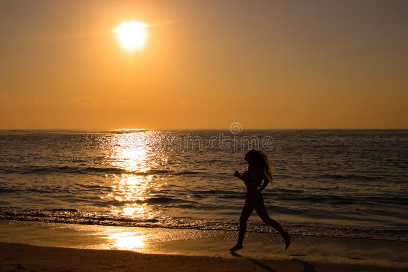 Female Running Along the Beach Stock Photo - Image of reflection ...