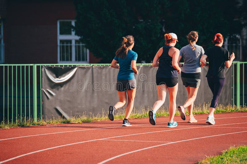 Female Running Training in Group. Sport Photo, Teamwork and Motivation ...