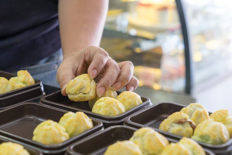 Female`s Hand Decorate of Choux Pastry with Cream Stock Photo - Image ...