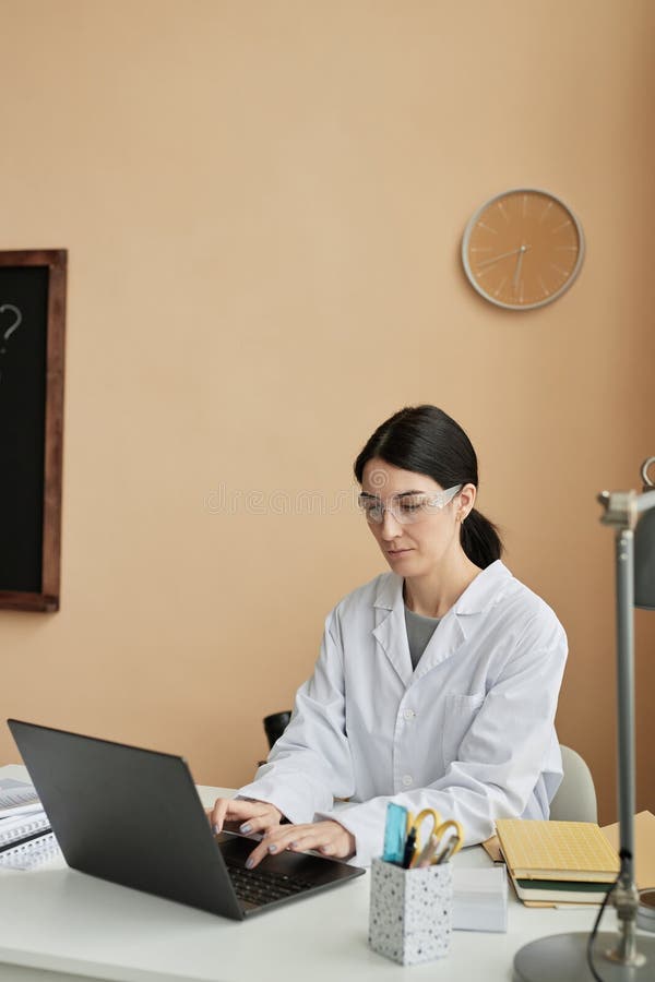 Female Science Class Teacher Using Laptop in Classroom Above Stock ...