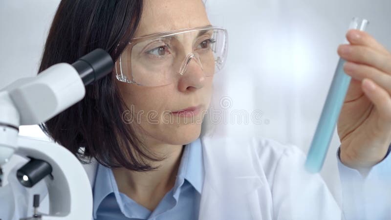 Female Scientist Analyzing Sample in Laboratory. Focused Female ...
