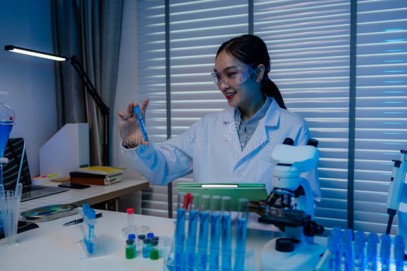 A Female Scientist is Experimenting with Chemicals in a Lab, Science ...