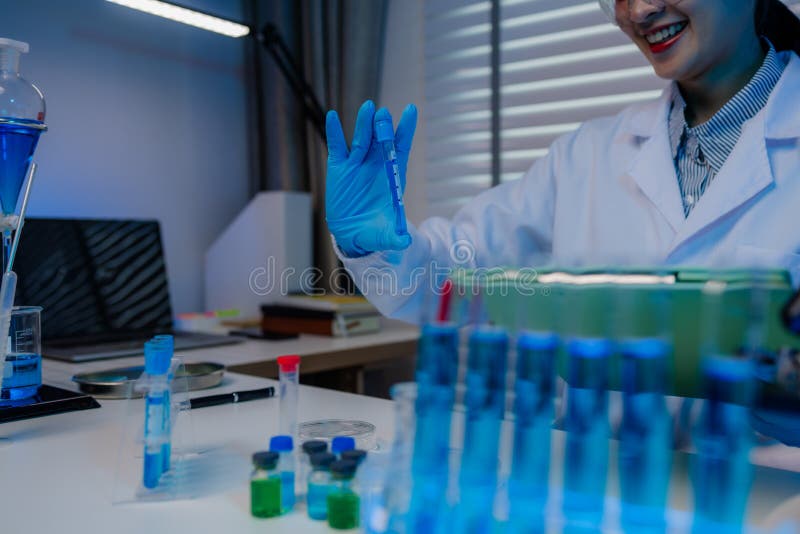 A Female Scientist is Experimenting with Chemicals in a Lab, Science ...