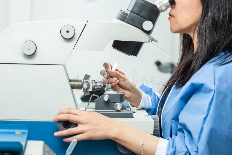 Female Scientist Placing a Sample on a Transmission Electron Microscopy ... Female Scientist Placing a Sample on a Transmission Electron Microscopy ...