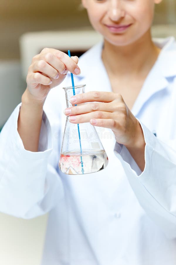 Female Scientist Shaking a Liquid in an Erlenmeyer Stock Photo - Image ...