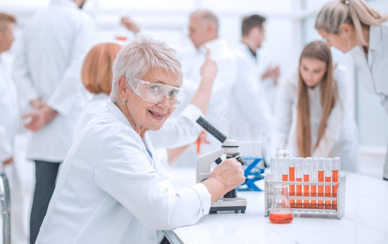 Female Scientist Sitting at a Desk in the Laboratory. Stock Image ...
