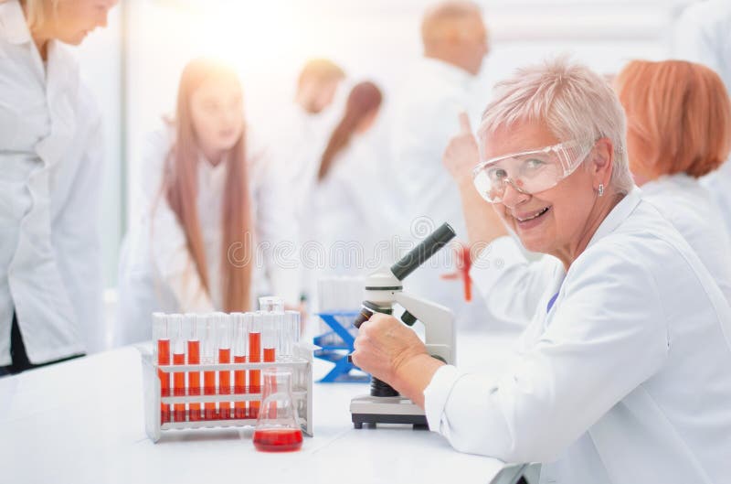 Female Scientist Sitting at a Desk in the Laboratory. Stock Image ...