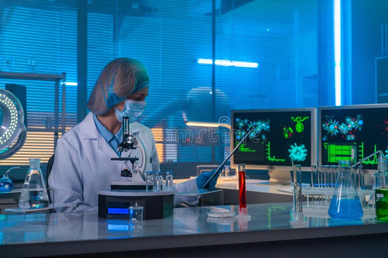 Female Scientist Sitting in a Research Lab with Test Tubes and Flasks ...