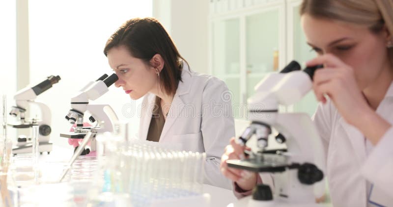 Female Scientist Uses Microscope in Laboratory Setting Stock Footage ...