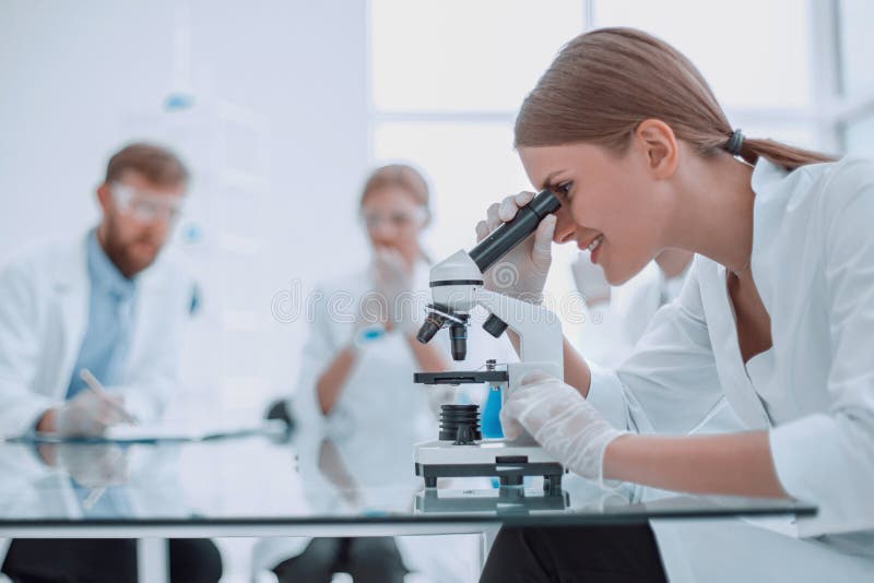 Female Scientist Using a Microscope in a Chemical Laboratory Stock ...