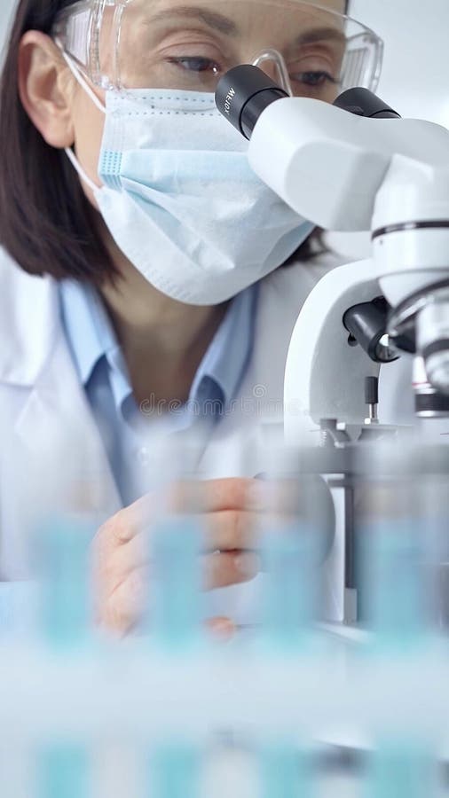 Female Scientist Using Microscope in Laboratory, Portrait. Focus on a ...