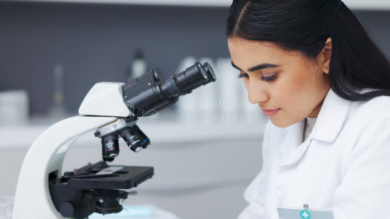 Female Scientist Using a Microscope in a Research Lab. Young Biologist ...
