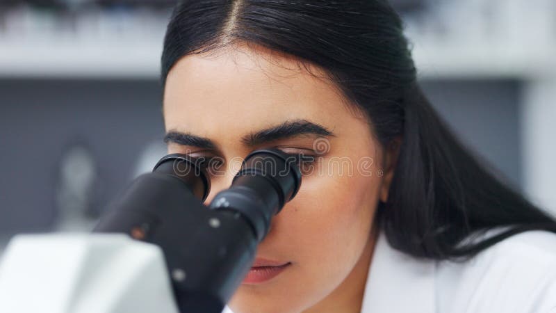 Female Scientist Using a Microscope in a Research Lab. Young Biologist ...