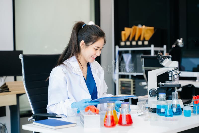 Female Scientist Working with Micro Pipettes Analyzing Biochemical ...