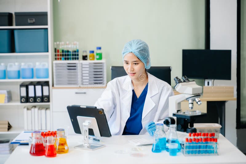 Female Scientist Working with Micro Pipettes Analyzing Biochemical ...