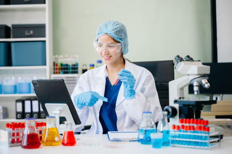 Female Scientist Working with Micro Pipettes Analyzing Biochemical ...