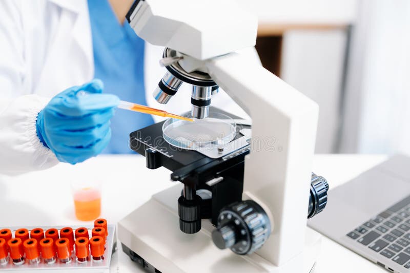Female Scientist Working with Micro Pipettes Analyzing Biochemical ...