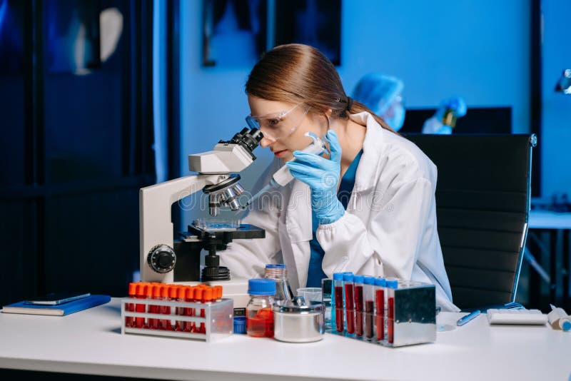 Female Scientist Working with Micro Pipettes Analyzing Biochemical ...