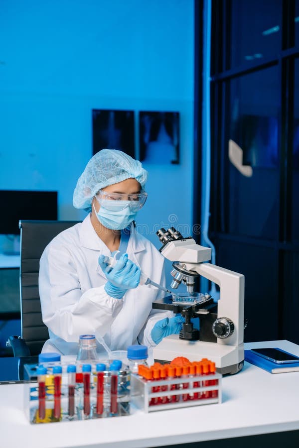 Female Scientist Working with Micro Pipettes Analyzing Biochemical ...