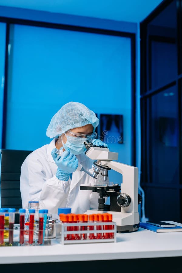 Female Scientist Working with Micro Pipettes Analyzing Biochemical ...