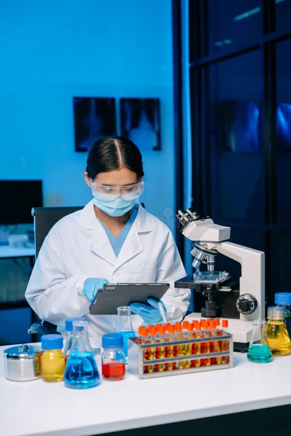 Female Scientist Working with Micro Pipettes Analyzing Biochemical ...