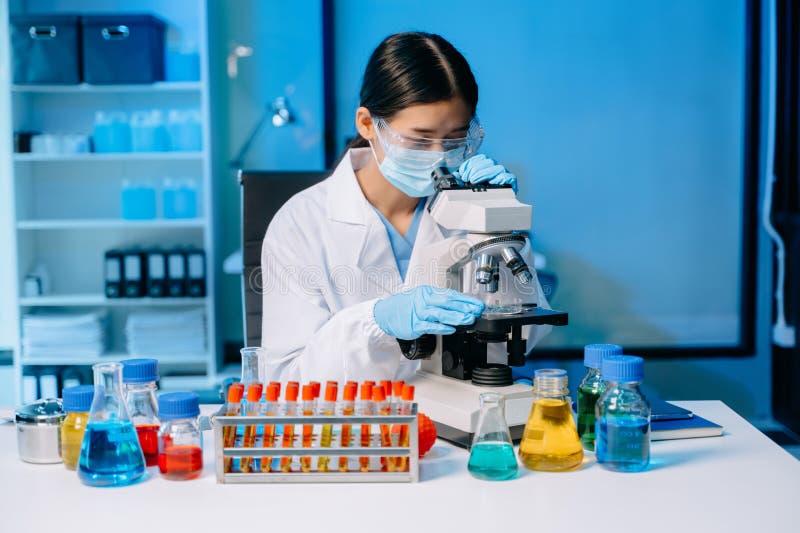 Female Scientist Working with Micro Pipettes Analyzing Biochemical ...