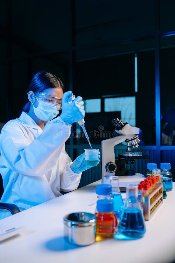 Female Scientist Working with Micro Pipettes Analyzing Biochemical ...