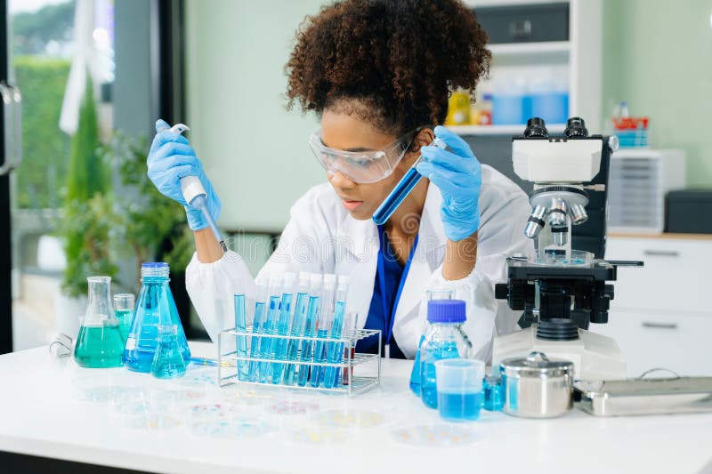 Female Scientist Working with Micro Pipettes Analyzing Biochemical ...