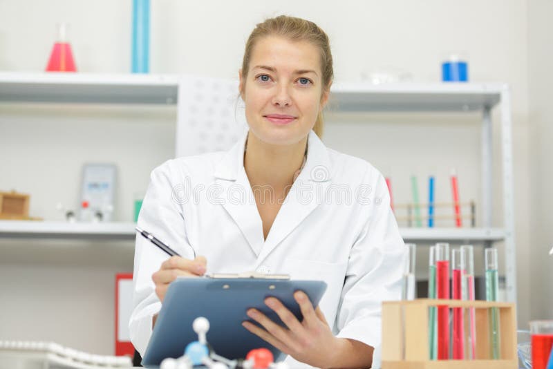 Female Scientist Writing on Clipboard Stock Image - Image of female ...