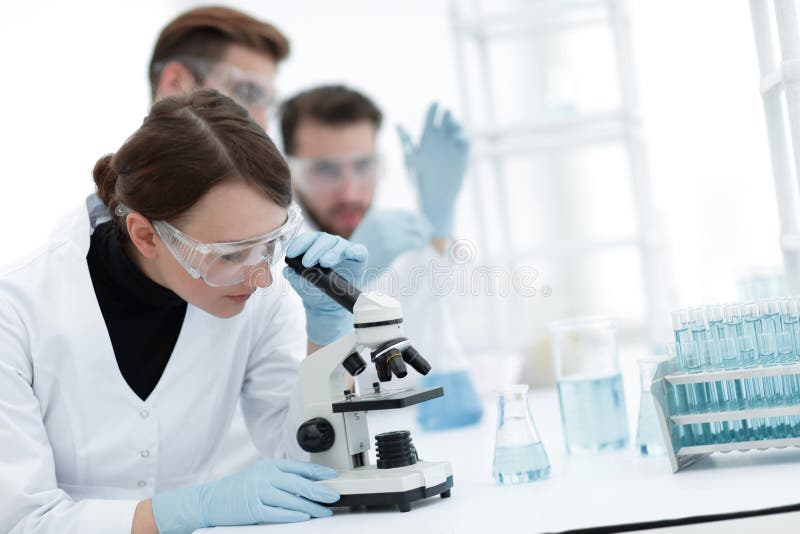 Female Scientists Looking into a Microscope Stock Image - Image of ...