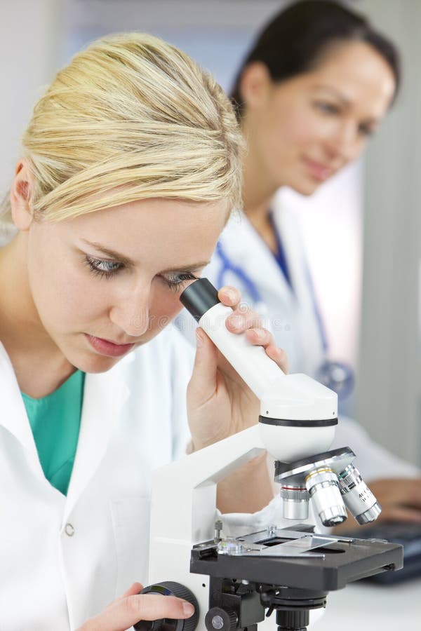 Female Scientists Using Microscopes in Laboratory Stock Image - Image ...