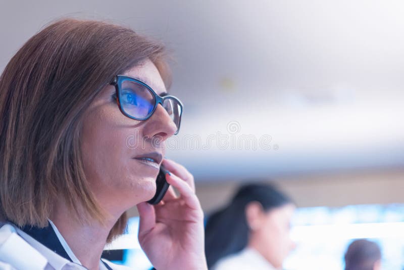 Female Security Guard Operator Talking on the Phone, Calling in the ...