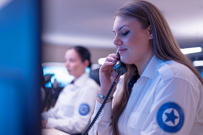 Female Security Guard Operator Talking on the Phone, Calling in the ...