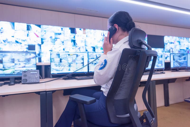 Female Security Guard Operator Talking on the Phone, Calling in the ...