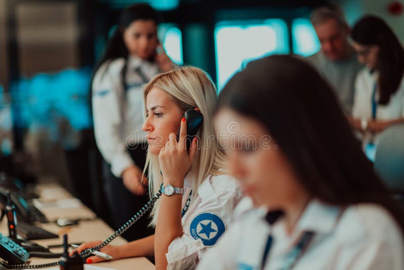 Female Security Guard Operator Talking on the Phone while Working at ...