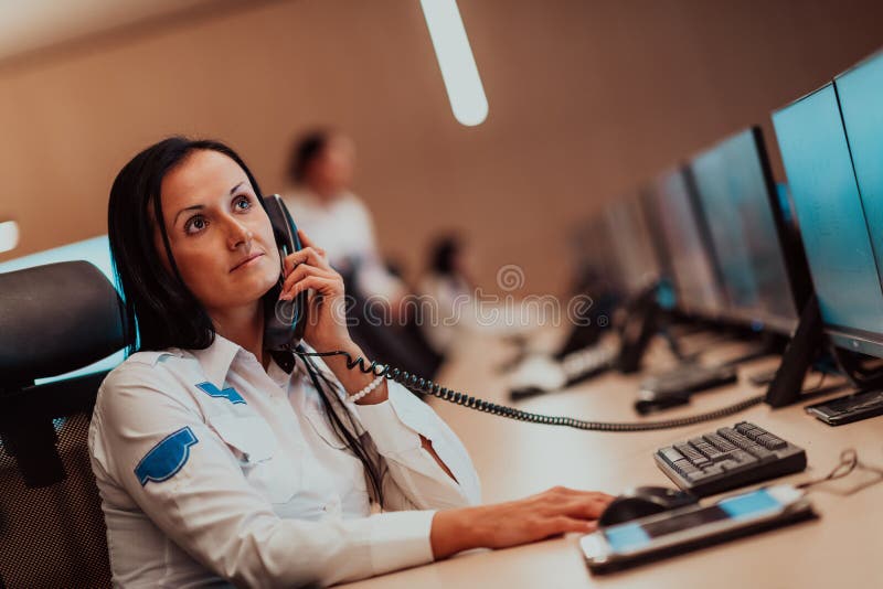 Female Security Guard Operator Talking on the Phone while Working at ...
