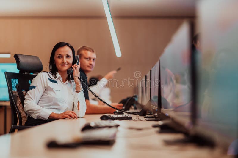 Female Security Guard Operator Talking on the Phone while Working at ...