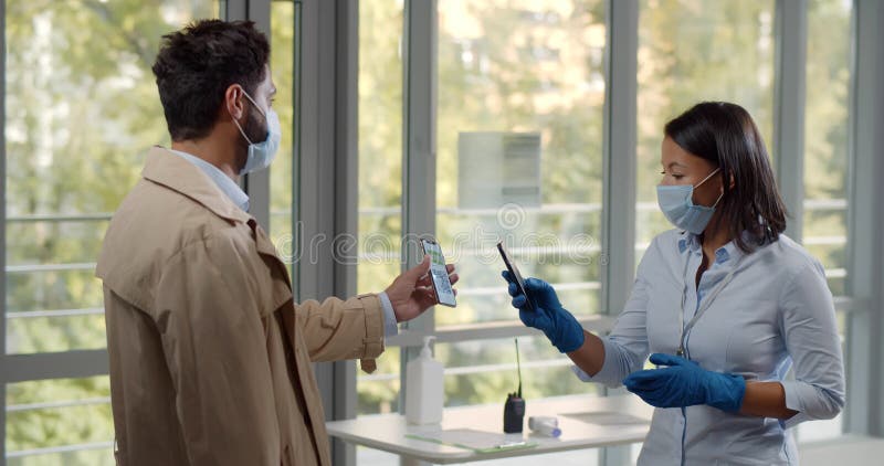 Female Security Guard in Safety Mask and Gloves Scan Vaccination Qr ...
