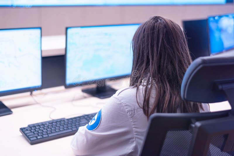 Female Security Guard Working on Computers while Sitting in the Main ...
