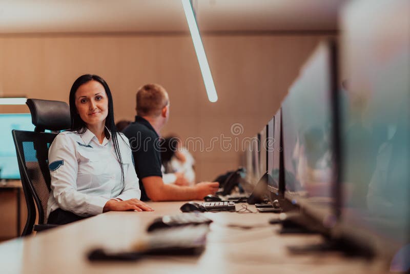Female Security Operator Working in a Data System Control Room Offices ...
