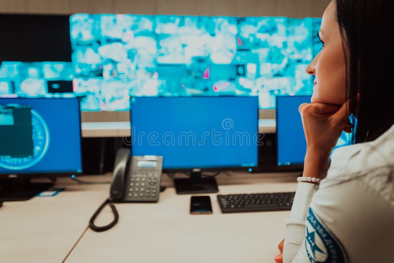 Female Security Operator Working in a Data System Control Room Offices ...
