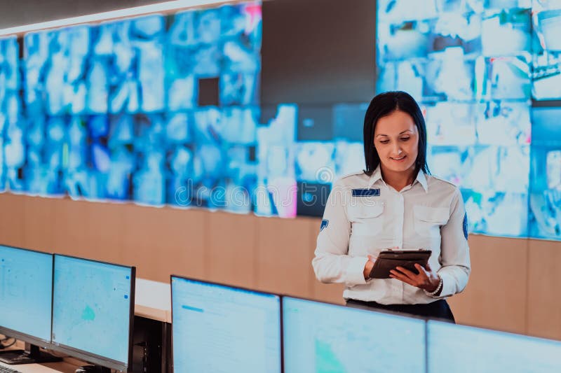 Female Security Operator Working in a Data System Control Room Offices ...