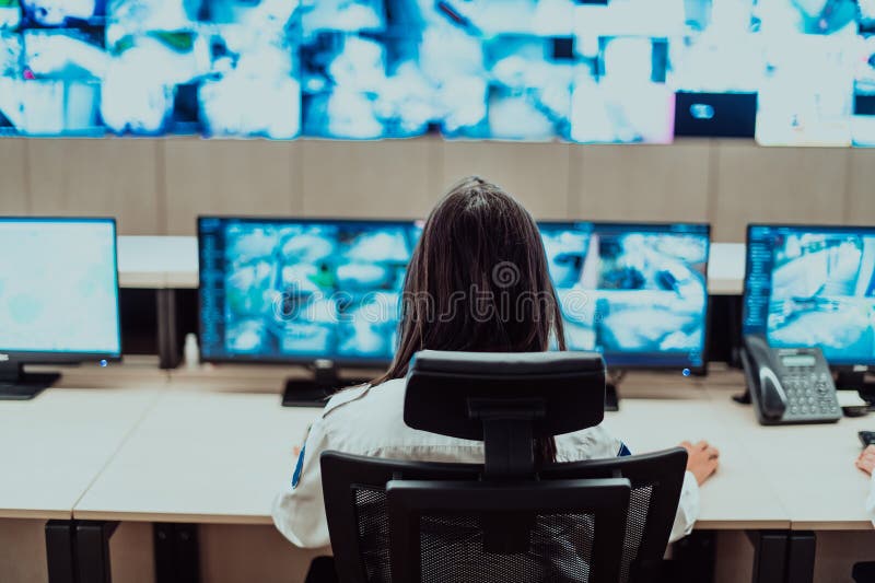 Female Security Operator Working in a Data System Control Room Offices ...