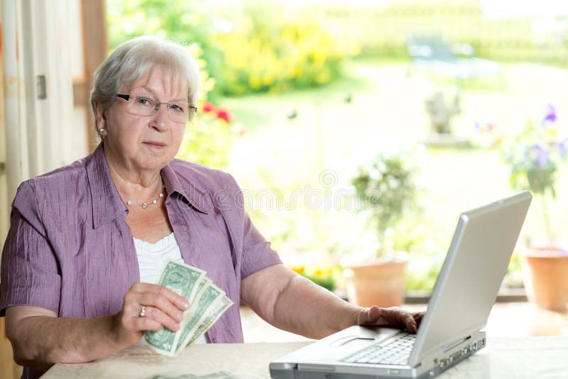 Female Senior with Money is Using Computer Stock Photo - Image of money ...