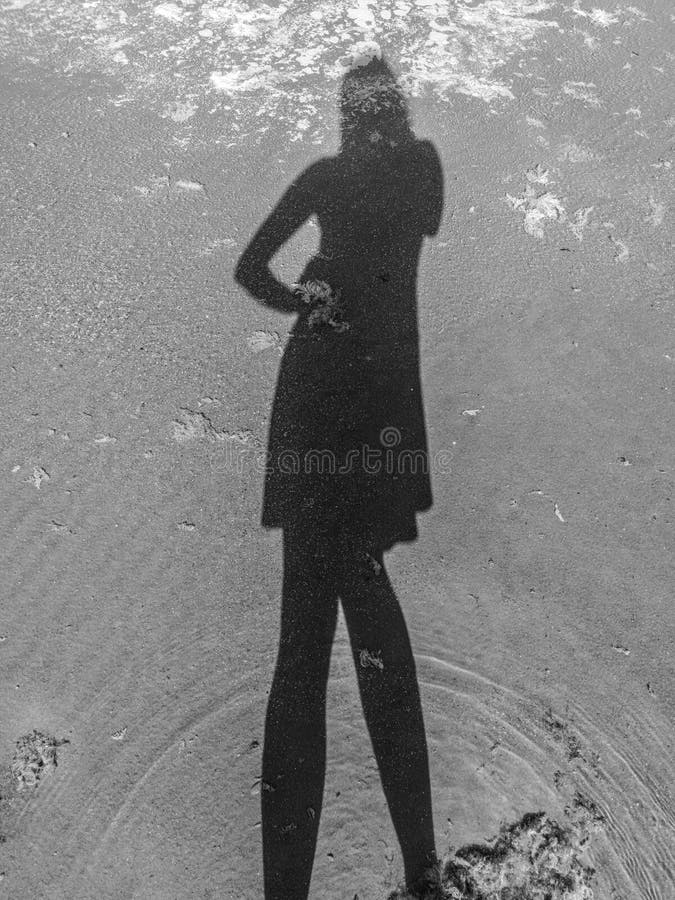 Female shadow at beach stock photo. Image of footwear - 230568248